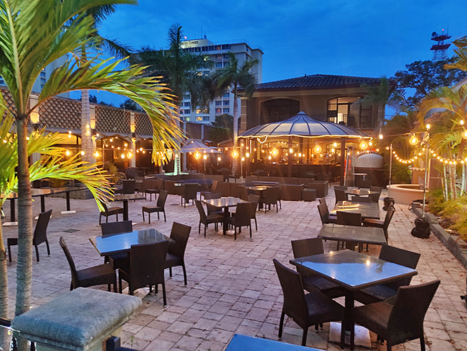Palm trees sway gently over Ember & Oak's inviting patio, where Florida sunshine and culinary excellence meet in perfect harmony.