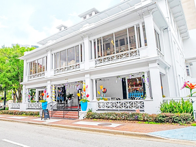 The grand white mansion housing Sweet Pete's stands like a sugar palace against Jacksonville's blue sky, promising sweet adventures within.