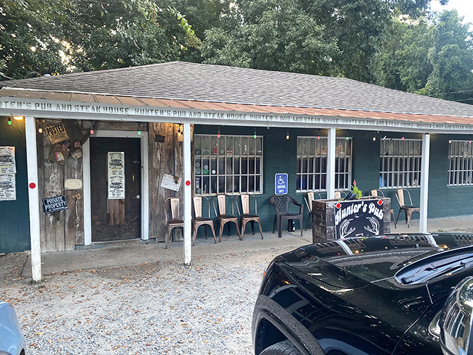 The American flag stands proud outside this unassuming green building where beef dreams come true. Hunter's modest exterior conceals culinary treasures within.