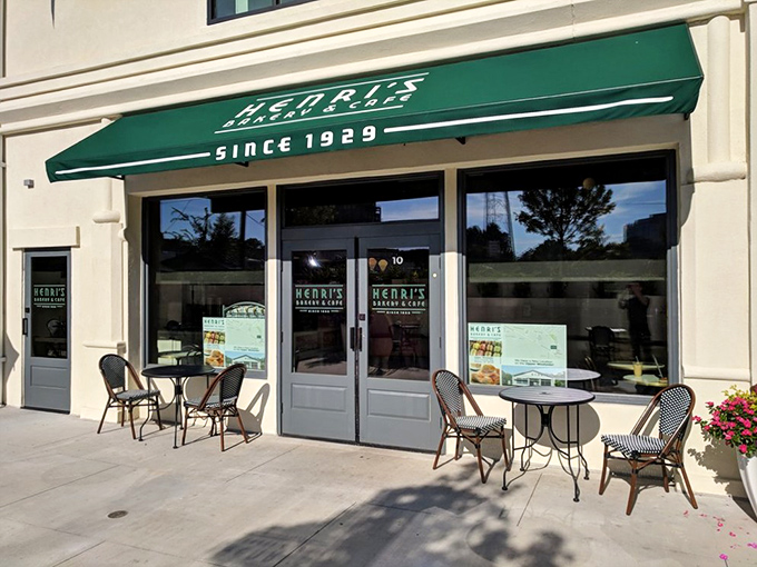 A little slice of heaven with green umbrellas providing shade as diners enjoy their meal on Henri's inviting outdoor patio. The perfect urban oasis.