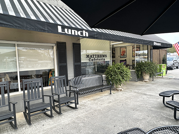 The classic striped awning of Matthews Cafeteria stands like a beacon of comfort food, promising Southern delights within these unassuming walls. 