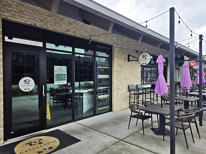 Modern farmhouse meets culinary playground at Cattle Shed's inviting exterior. String lights and comfortable outdoor seating promise evenings of beef-centric bliss in Alpharetta.