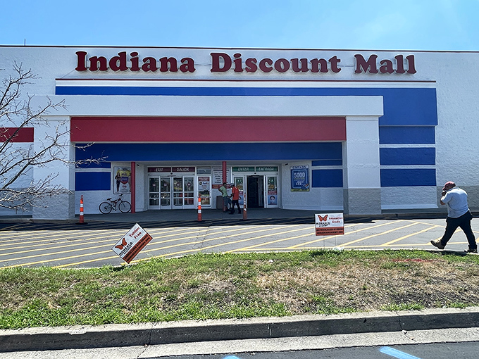 The red, white, and blue exterior serves as a retail lighthouse, guiding bargain hunters to shores where deals await and wallets breathe sighs of relief.