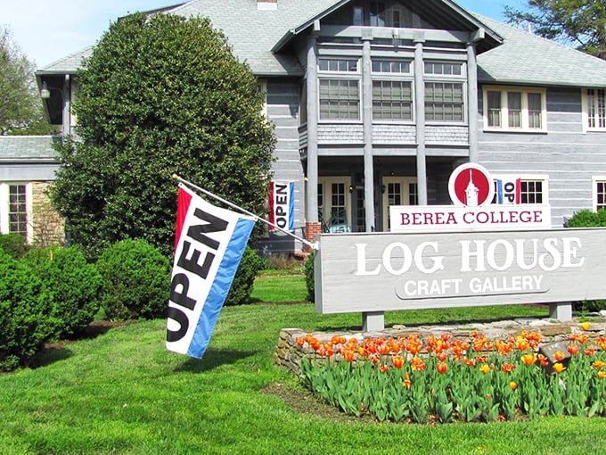 The stately blue Log House Craft Gallery stands like a guardian of Appalachian tradition, proudly displaying its Berea College heritage beneath Kentucky's endless sky. 