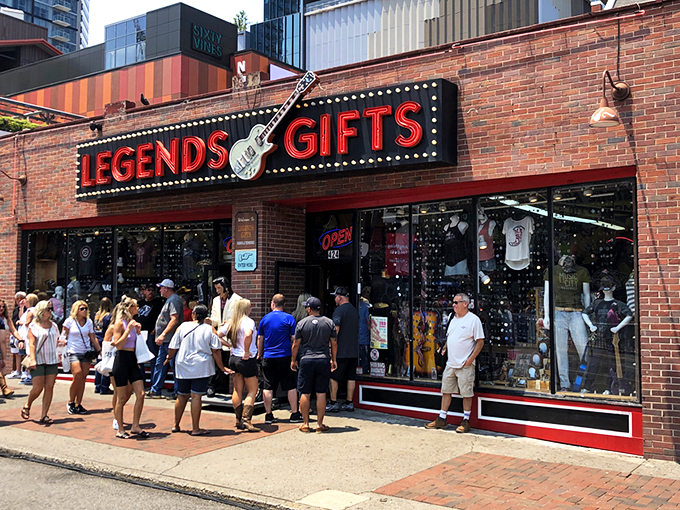 The iconic red Legends Gifts storefront beckons like a siren song to Nashville visitors. That guitar silhouette isn't just decoration&mdash;it's a promise of melodious treasures within.