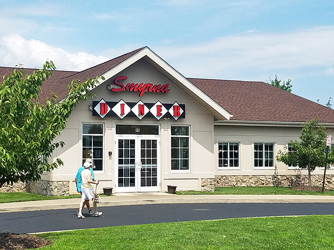 The iconic Smyrna Diner welcomes hungry travelers with its distinctive diamond-patterned sign and cozy stone facade. Delaware comfort food headquarters since the 1950s.