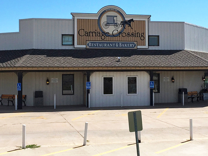 The white exterior of Carriage Crossing stands against a Kansas blue sky like a beacon of comfort food hope in Yoder's Amish country.