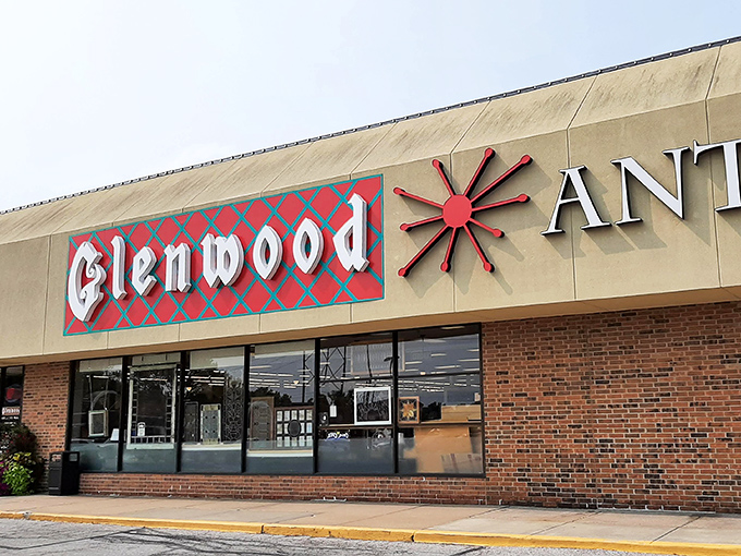 The iconic red and blue sign of Glenwood Antique Mall stands as a beacon to treasure hunters. Like a portal to the past, this unassuming exterior hides a universe of wonders within.