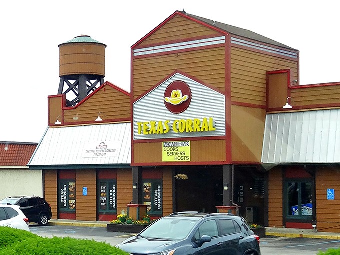 The iconic Texas Corral exterior stands like a Western movie set in suburban Indiana, complete with that charming water tower that says "yes, serious beef happens here."