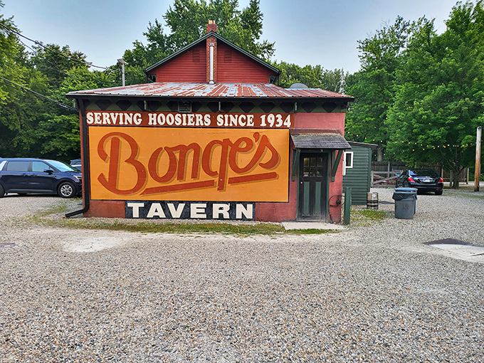 The unassuming exterior of Bonge's Tavern stands like a culinary secret hiding in plain sight, its weathered red siding and humble signage belying the gastronomic treasures within.