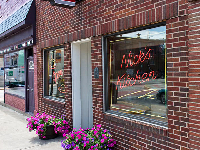 The iconic neon sign of Nick's Kitchen beckons like a lighthouse for hungry travelers in downtown Huntington. Comfort food paradise awaits!