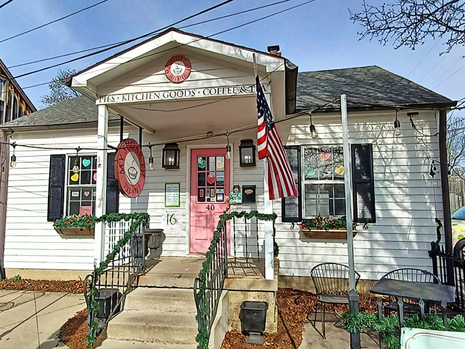 The white cottage with that irresistible pink door isn't just inviting—it's practically daring you to come inside and indulge.