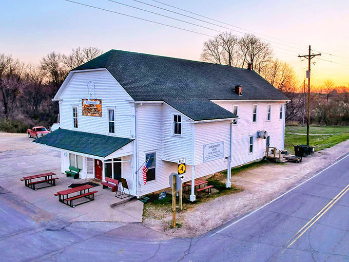 The white clapboard exterior with its cherry-red door isn't trying to impress anyone, which is exactly why it's so impressive. Small-town Kansas perfection.