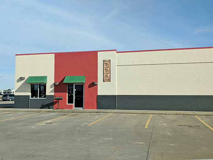 The bright red exterior of Woodies BBQ stands like a beacon for hungry travelers, promising smoky delights within those humble walls.