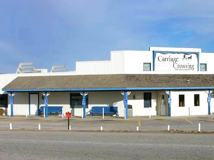 The blue and white exterior of Carriage Crossing stands against a Kansas blue sky like a beacon of comfort food hope in Yoder's Amish country.
