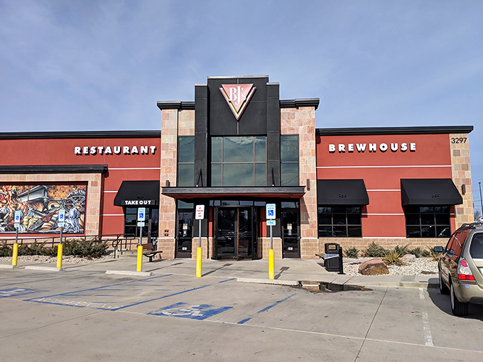 The bold red exterior of BJ's stands like a beacon for hungry travelers, promising craft brews and comfort food within those stone-accented walls.