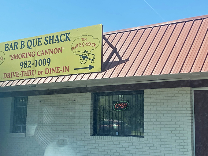 The unassuming exterior hides barbecue greatness like a superhero's secret identity. That yellow sign is Jacksonville's equivalent of the Bat Signal for hungry locals.