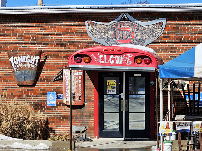 The unassuming brick exterior promises barbecue greatness with its cheeky welcome sign and flame-adorned entryway. Meat paradise awaits. 
