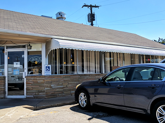 The unassuming stone facade of Leon's might not stop traffic, but that heavenly smoke billowing from the roof? That's nature's most effective billboard.