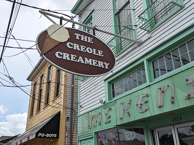 The mint-green facade of Creole Creamery stands like a sweet beacon on Prytania Street, promising frozen happiness within those historic walls.