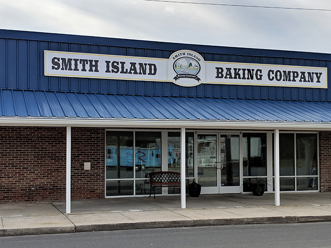 The blue-fronted bakery stands like a beacon of sweetness in Crisfield, promising layer upon layer of Maryland tradition behind those glass doors.