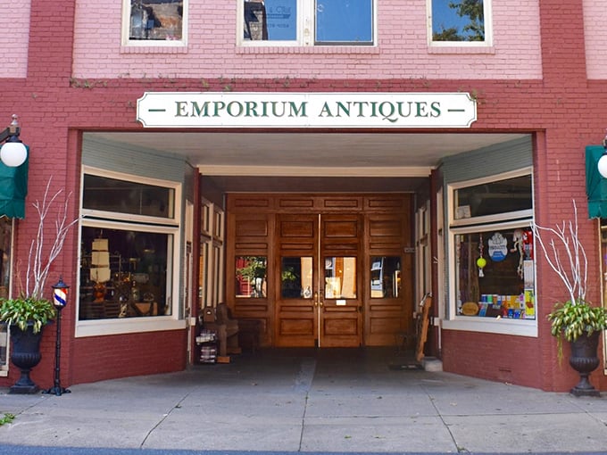 The brick facade of Emporium Antiques beckons like a time portal on Frederick's historic street. Vintage lampposts add that perfect nostalgic touch.