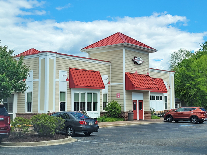 The unassuming exterior of Adams Grille & Tap House with its signature red roof beckons like a barbecue lighthouse guiding hungry travelers home.