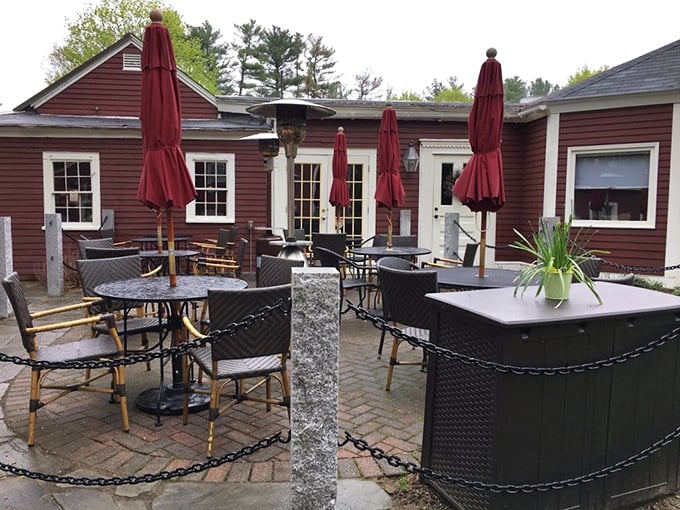 The unassuming burgundy exterior of Rapscallion Table & Tap holds culinary treasures that belie its modest appearance, like finding a Michelin star in a phone booth.