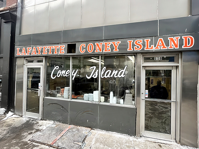 The iconic Lafayette Coney Island fa&ccedil;ade glows like a beacon for hungry night owls, promising Detroit's most famous comfort food against the city skyline.