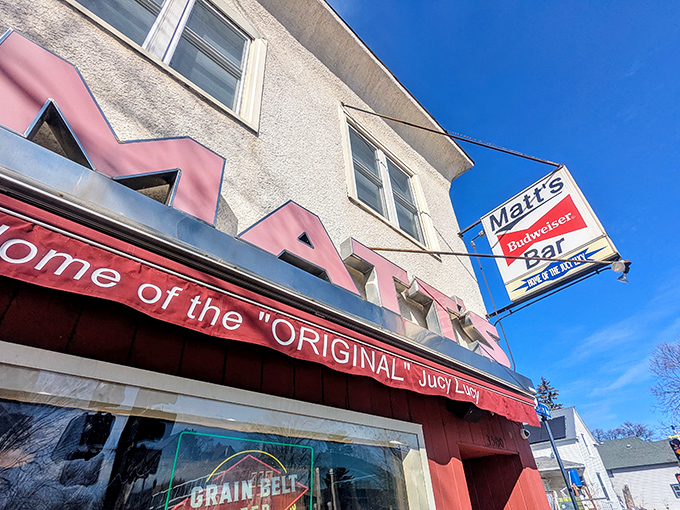 The unassuming exterior of Matt's Bar stands like a humble temple to burger perfection, its red and white facade hiding culinary treasures within.