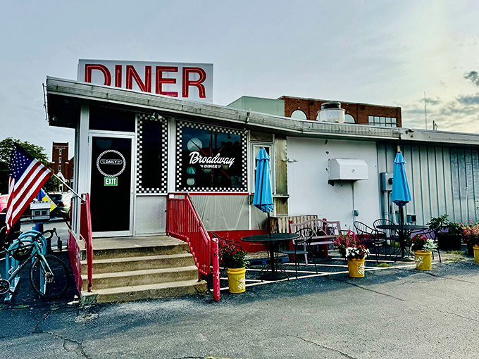 The classic checkerboard trim instantly telegraphs "authentic diner experience ahead" &ndash; a roadside beacon promising comfort food and conversation in equal measure. 