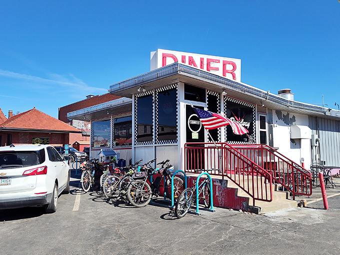 The classic checkerboard trim instantly telegraphs "authentic diner experience ahead" &ndash; a roadside beacon promising comfort food and conversation in equal measure. 