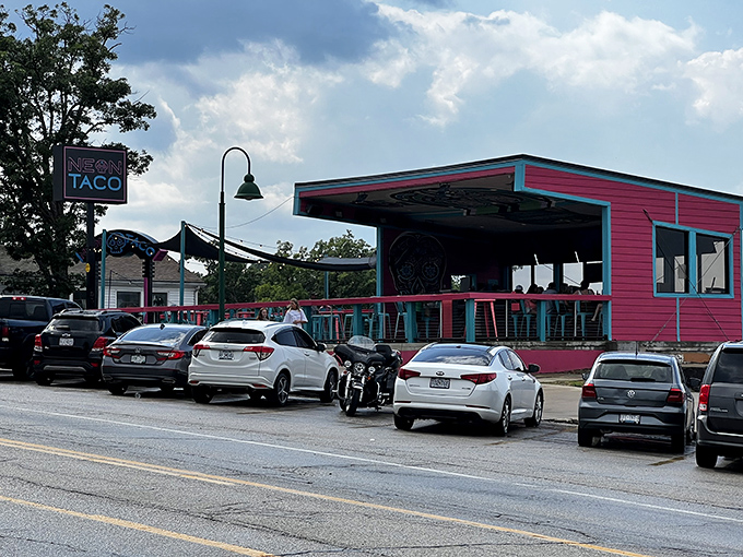 The neon dream beckons from the shoreline, a pink and turquoise beacon promising coastal flavors in the heart of Missouri's lake country.