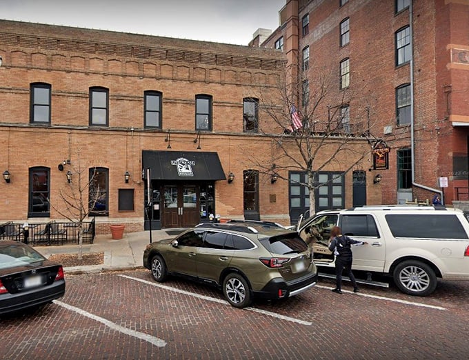 The historic brick facade of Upstream Brewing Company stands proudly in Omaha's Old Market, its former firehouse identity preserved with architectural integrity and charm.