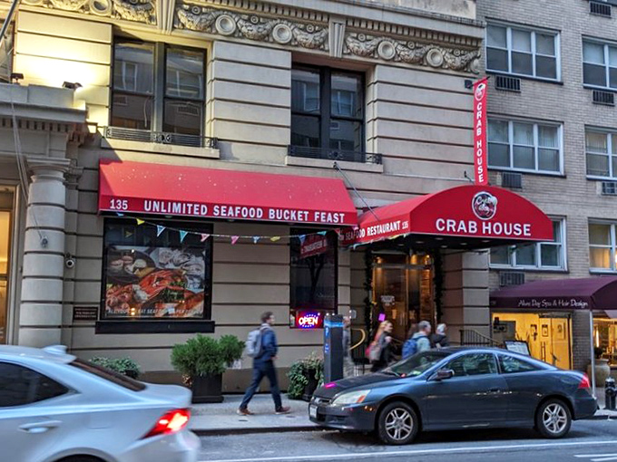 The bright red awning reading "UNLIMITED SEAFOOD BUCKET FEAST" works like a siren call to seafood lovers passing by on Manhattan's streets.