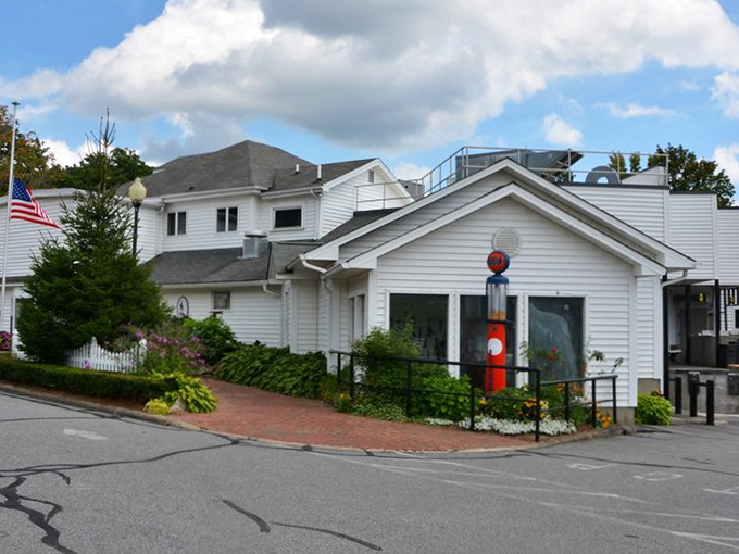 The white clapboard exterior with its American flag and welcoming porch feels like stepping into a Norman Rockwell painting of Southern hospitality. 