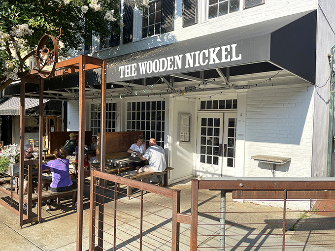 The Wooden Nickel's classic white facade stands proudly on Hillsborough's King Street, beckoning hungry travelers with the promise of comfort and conversation.