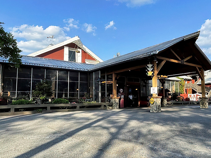 The iconic red exterior of Angus Barn welcomes diners like an old friend, its rustic charm and spacious porch promising memorable meals and Southern hospitality. 