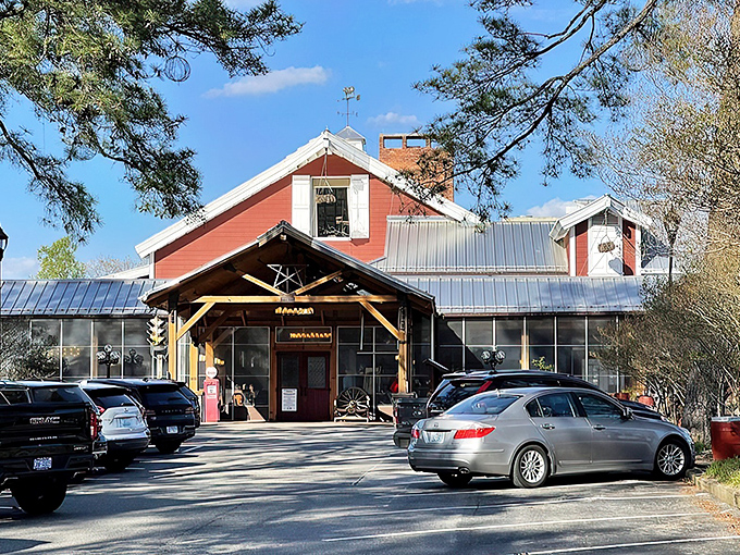 The iconic red exterior of Angus Barn welcomes diners like an old friend, its rustic charm and spacious porch promising memorable meals and Southern hospitality.