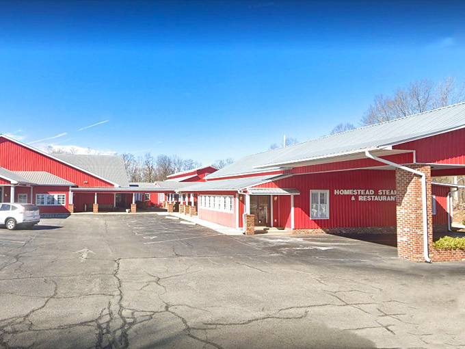 The barn-red exterior of Homestead Steakhouse stands proud against Carolina blue skies, like a beacon calling hungry travelers home. 