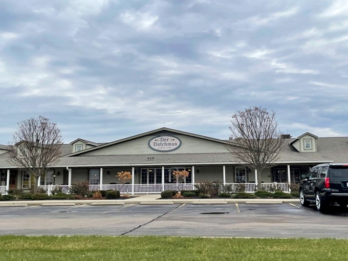 The welcoming facade of Der Dutchman stands like a beacon of comfort food in Plain City, with its charming porch and country-style architecture inviting hungry travelers inside.