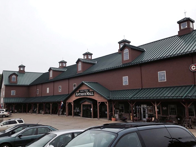 The rustic exterior of Berlin Village Antique Mall stands like a time portal in Ohio's Amish Country, promising treasures within its weathered wooden walls.