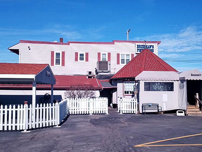 The iconic red-roofed entrance to Brennan's Fish House stands like a lighthouse beacon for hungry travelers. Seafood salvation awaits inside.