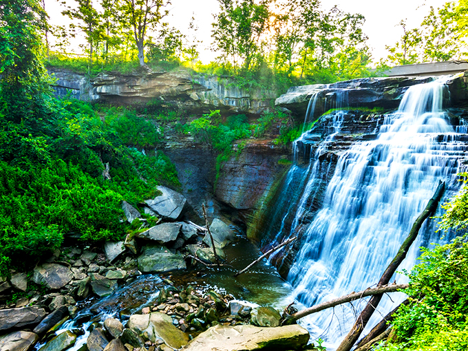 The boardwalk beckons through towering trees, promising the waterfall reveal that makes even seasoned travelers gasp. Nature's red carpet treatment, Ohio-style. 