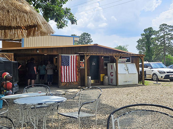 The thatched-roof entrance and rustic wooden exterior of The Hochahut beckons hungry travelers like a tropical oasis in Oklahoma's piney woods.