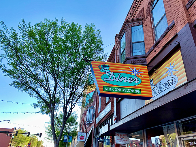 The Diner's vintage neon sign promises "AIR CONDITIONING" like it's 1955, a glowing beacon of breakfast hope on Norman's Main Street.