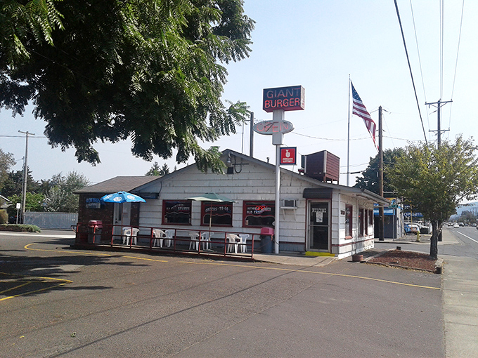 The iconic red and white Giant Burger sign stands tall against the Oregon sky, beckoning hungry travelers like a lighthouse for the famished.
