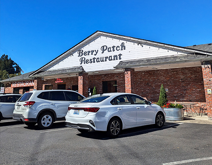 The brick-and-white exterior of Berry Patch Restaurant stands like a beacon of comfort food promise against Oregon's blue skies.
