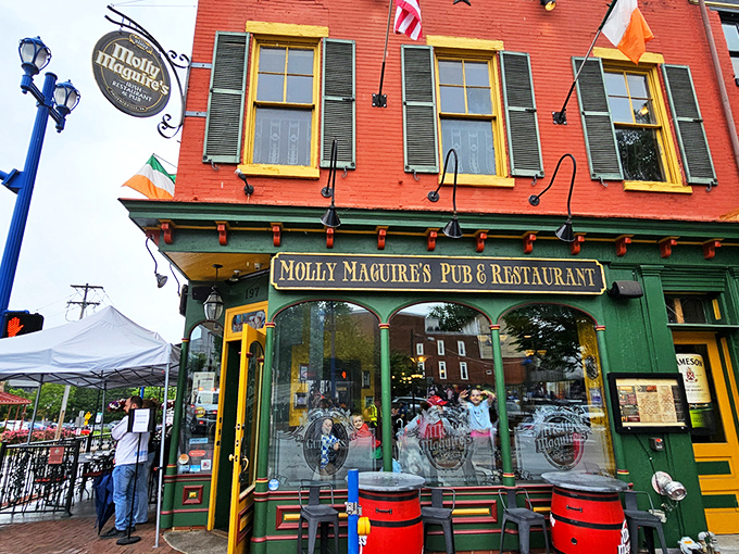 The warm brick exterior of Molly Maguire's glows at twilight, with the iconic Guinness sign promising authentic Irish hospitality within.