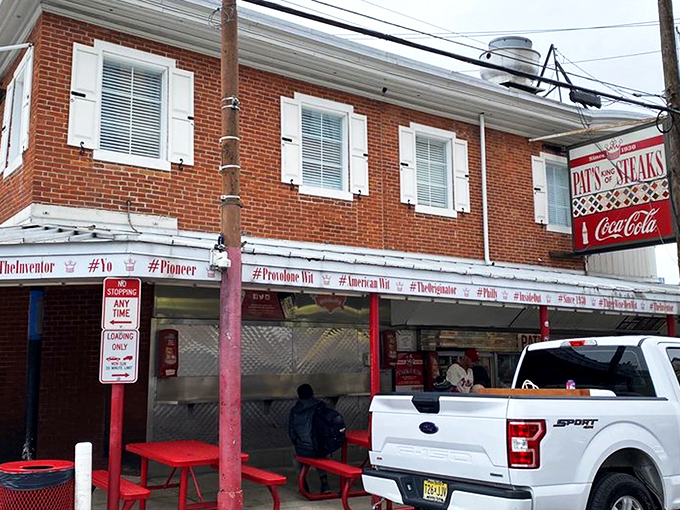 The brick-and-mortar kingdom where cheesesteak dreams come true since 1930. Pat's iconic red and white facade has witnessed nine decades of sandwich perfection.